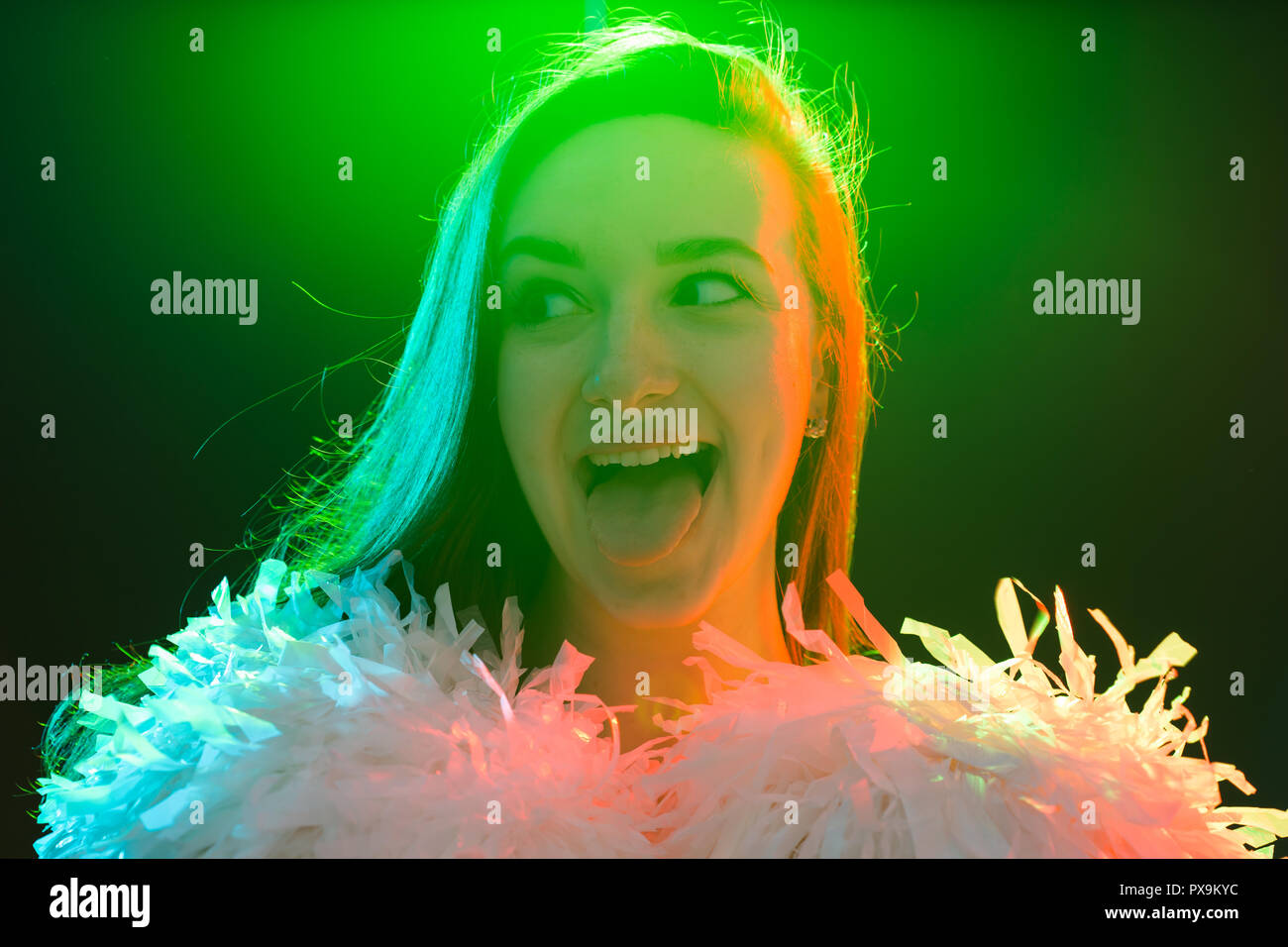 Portrait of cheerleading young woman dancing with pom-poms Stock Photo ...