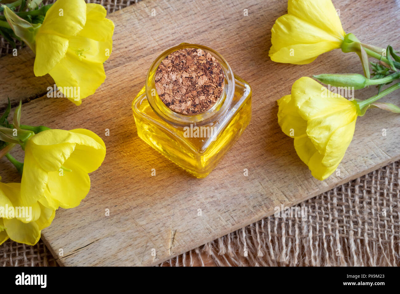 A bottle of evening primrose oil with fresh flowers Stock Photo - Alamy