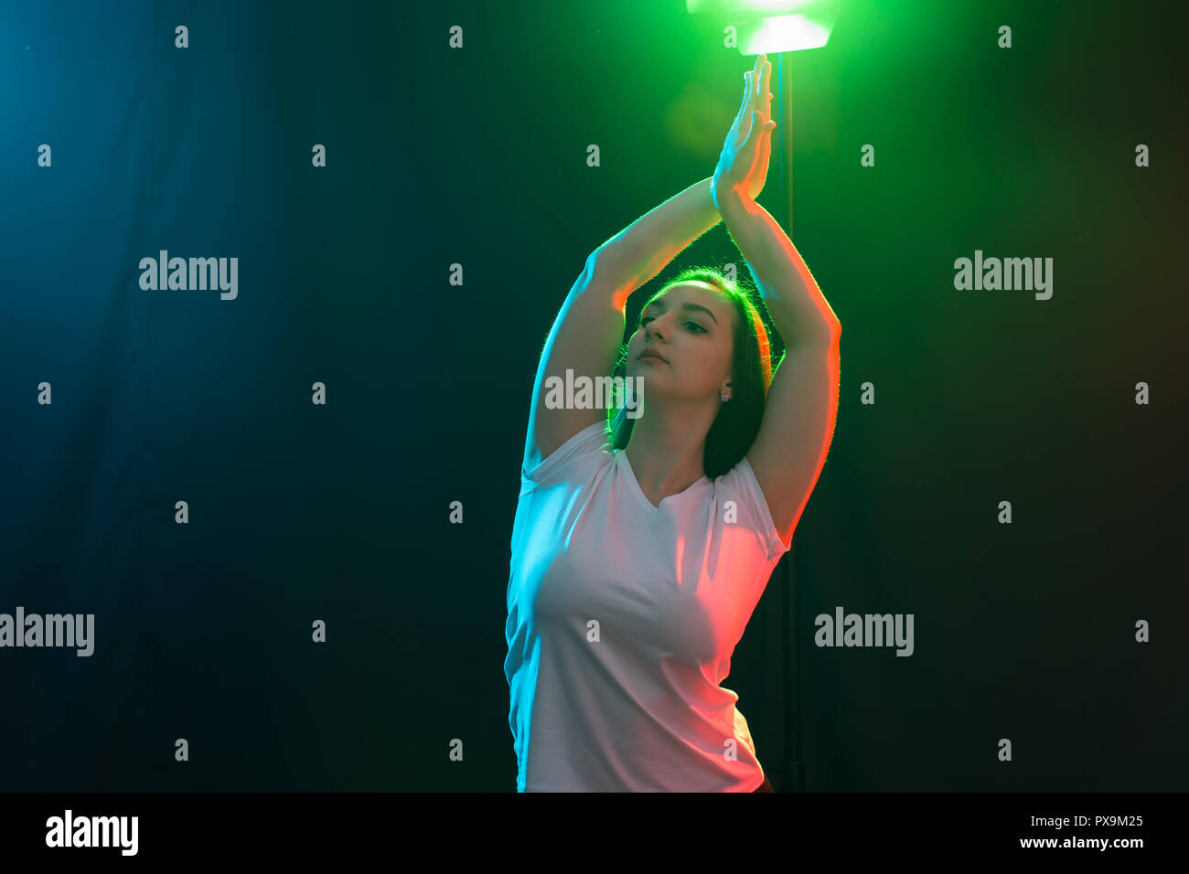 People and dancing concept - Young woman dancing jazz funk over colored ...