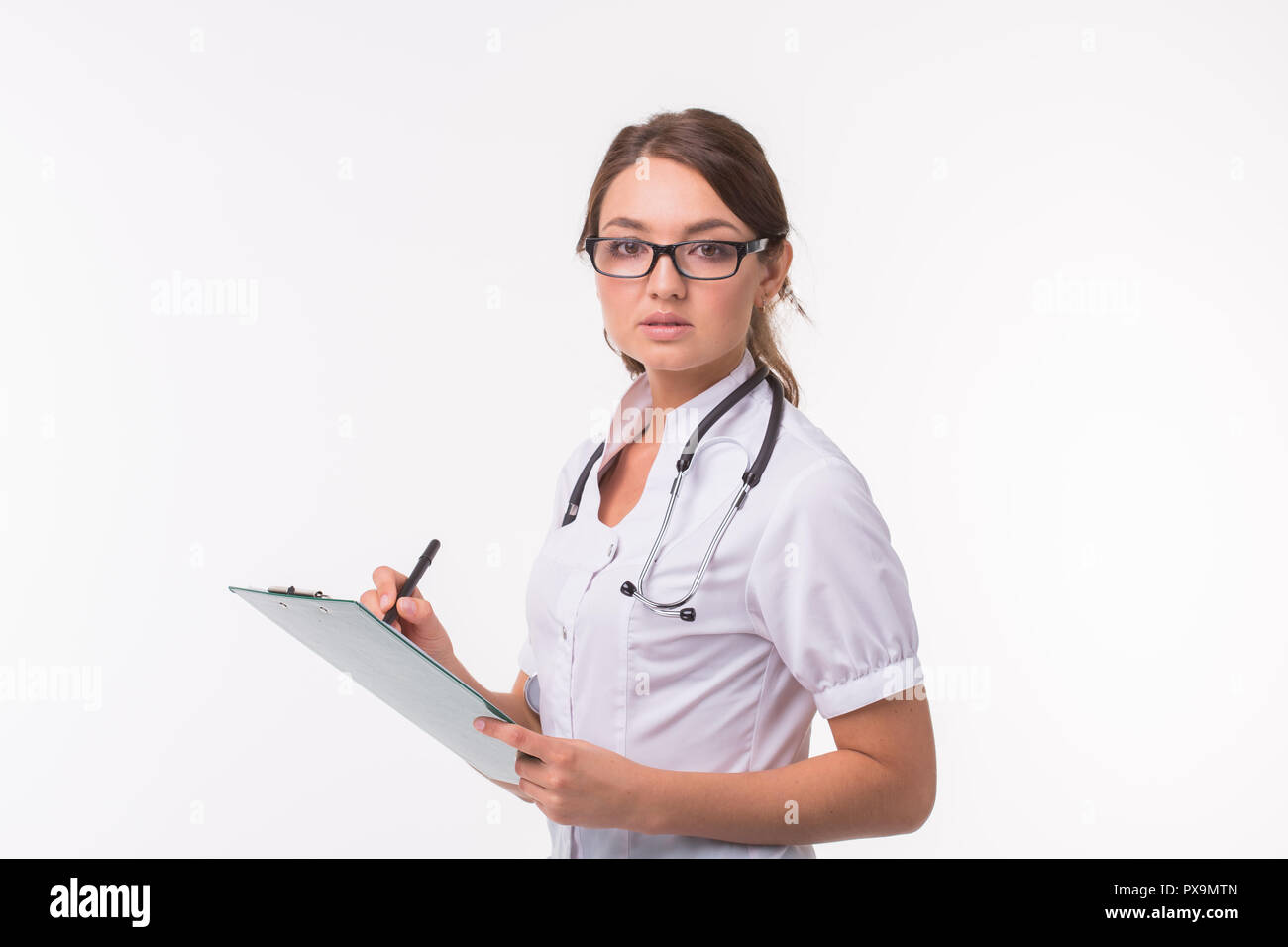 Female medicine doctor hand holding pen writing something on clipboard ...