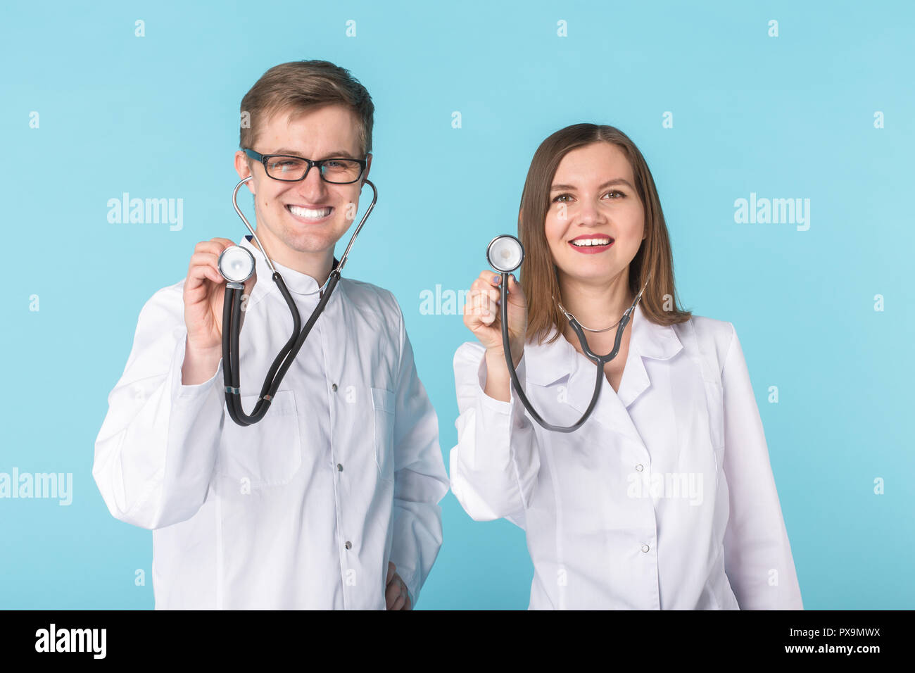 Two best smart professional smiling doctors workers in white coats ...