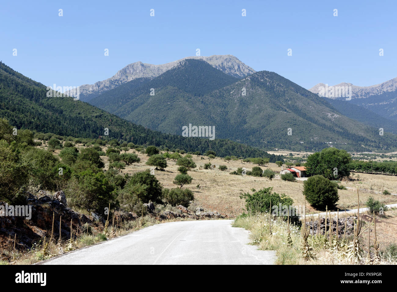 Road that borders Lake Stymphalia and surrounded by mountainous ...