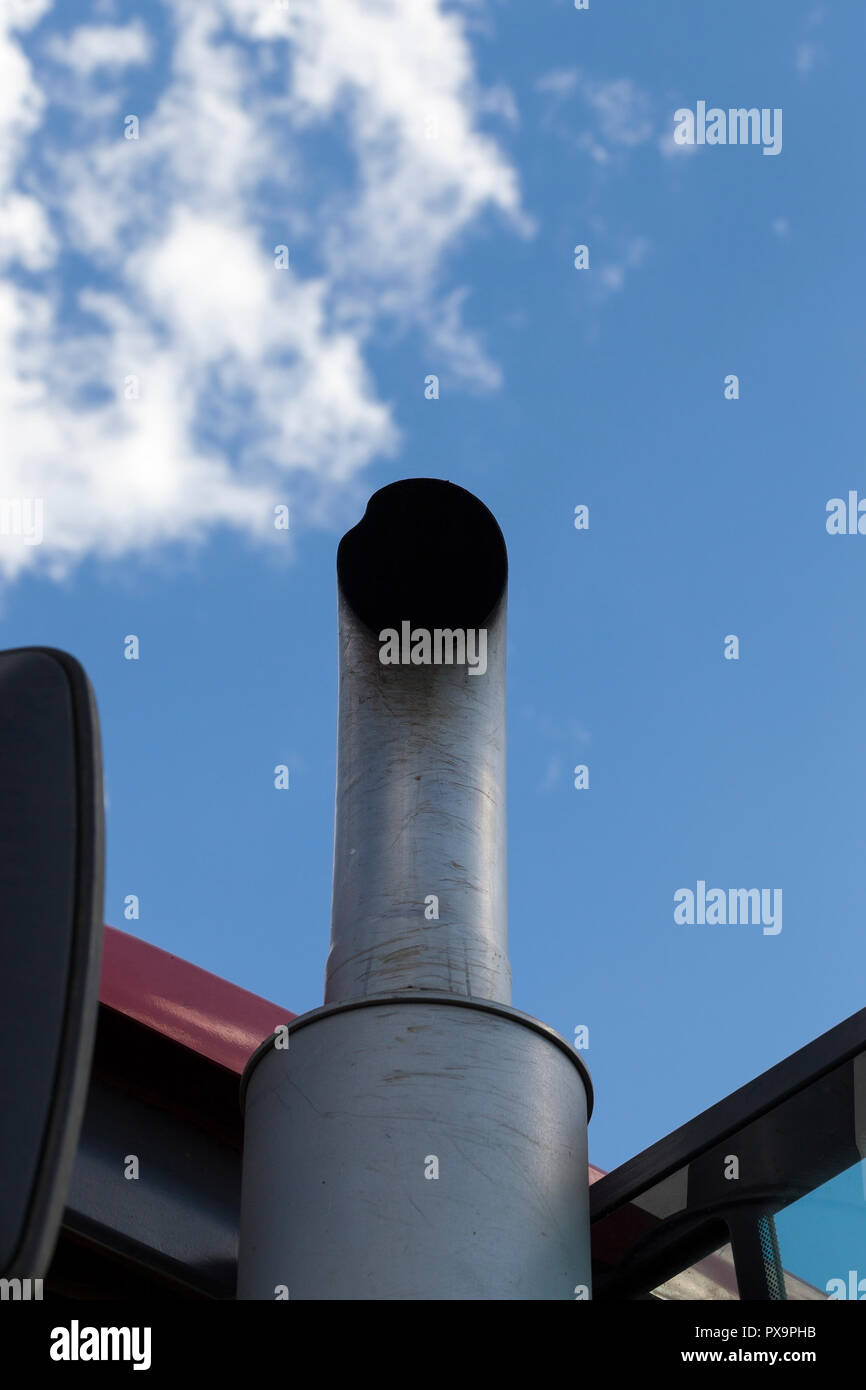 large pipe exhaust pipe on a tractor, close-up against a blue sky Stock ...