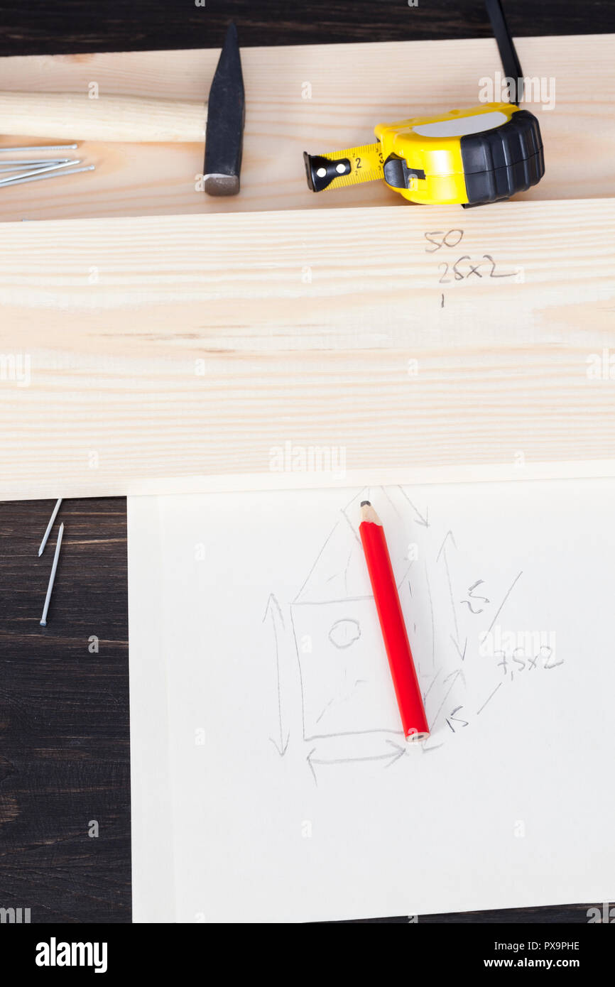 board, drawing on paper from a birdhouse and building tools for its ...