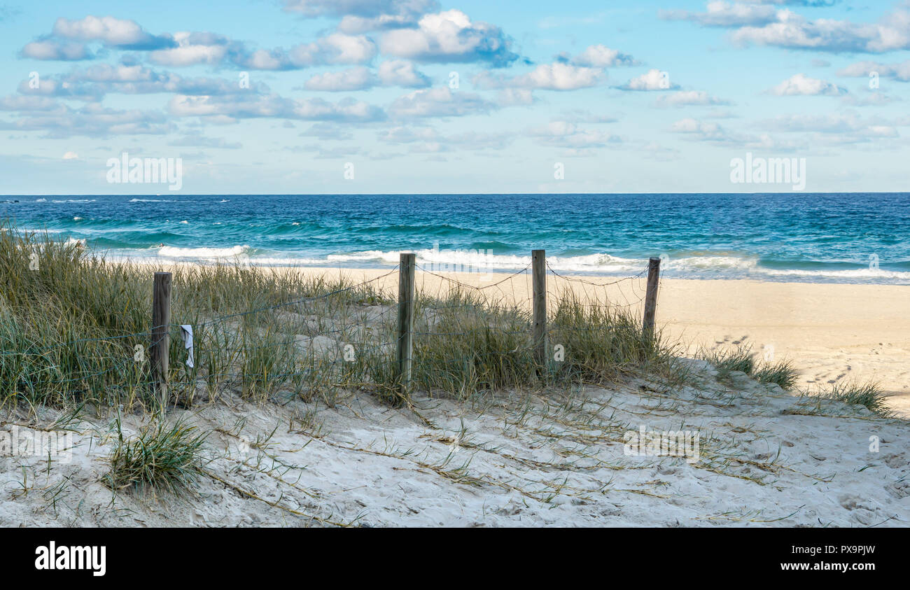 Standing on a beach looking out over the fence Stock Photo - Alamy
