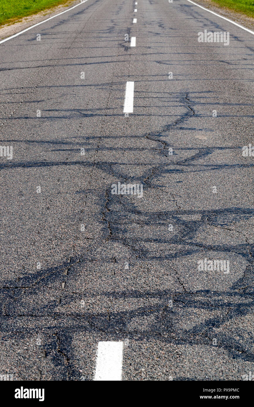 covered with a network of cracks asphalt road, the breakdown was ...