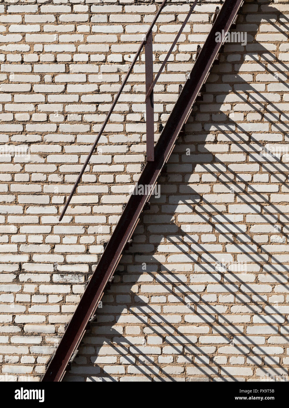 fire escape on a brick wall background of a building, sunny weather ...