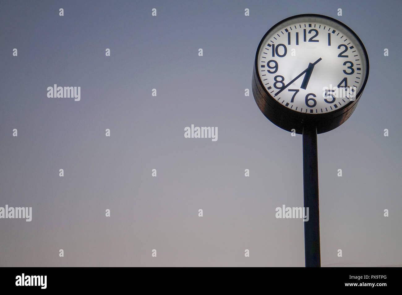 Analogue clock on pole Stock Photo - Alamy