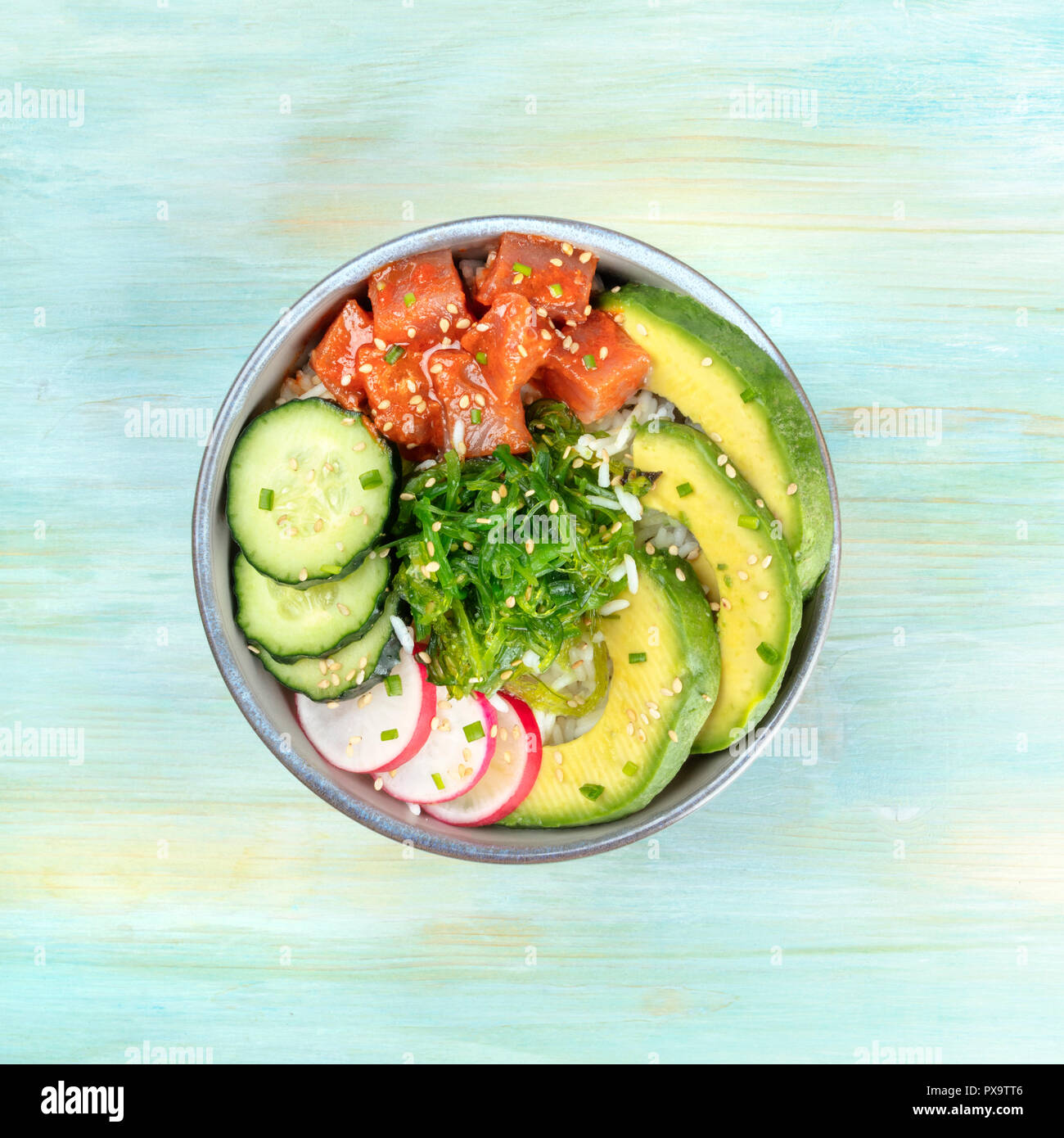 Hawaiian tuna poke salad on teal with copy space Stock Photo - Alamy