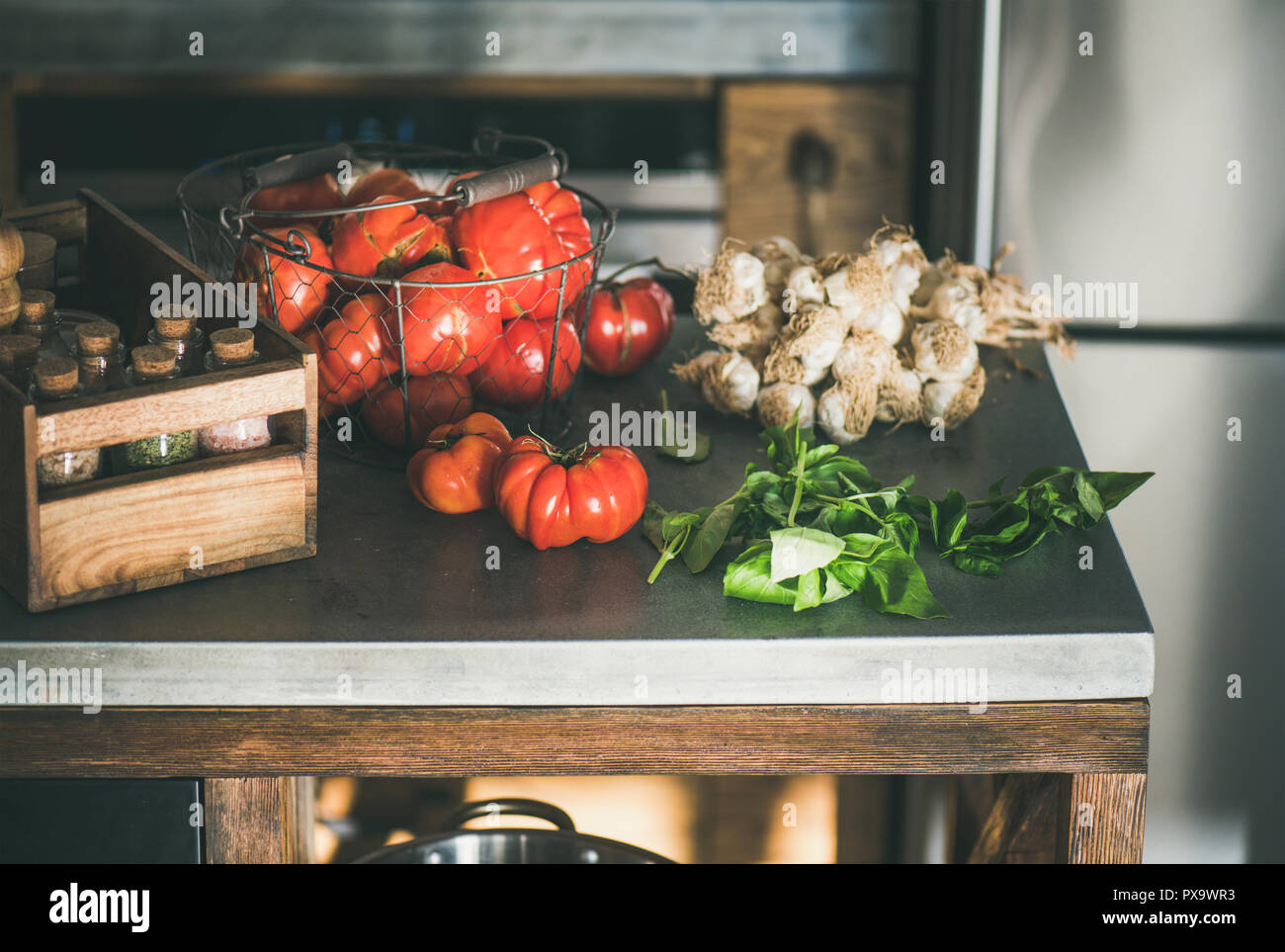 Kitchen counter with ingredients for cooking tomato sauce or pasta ...