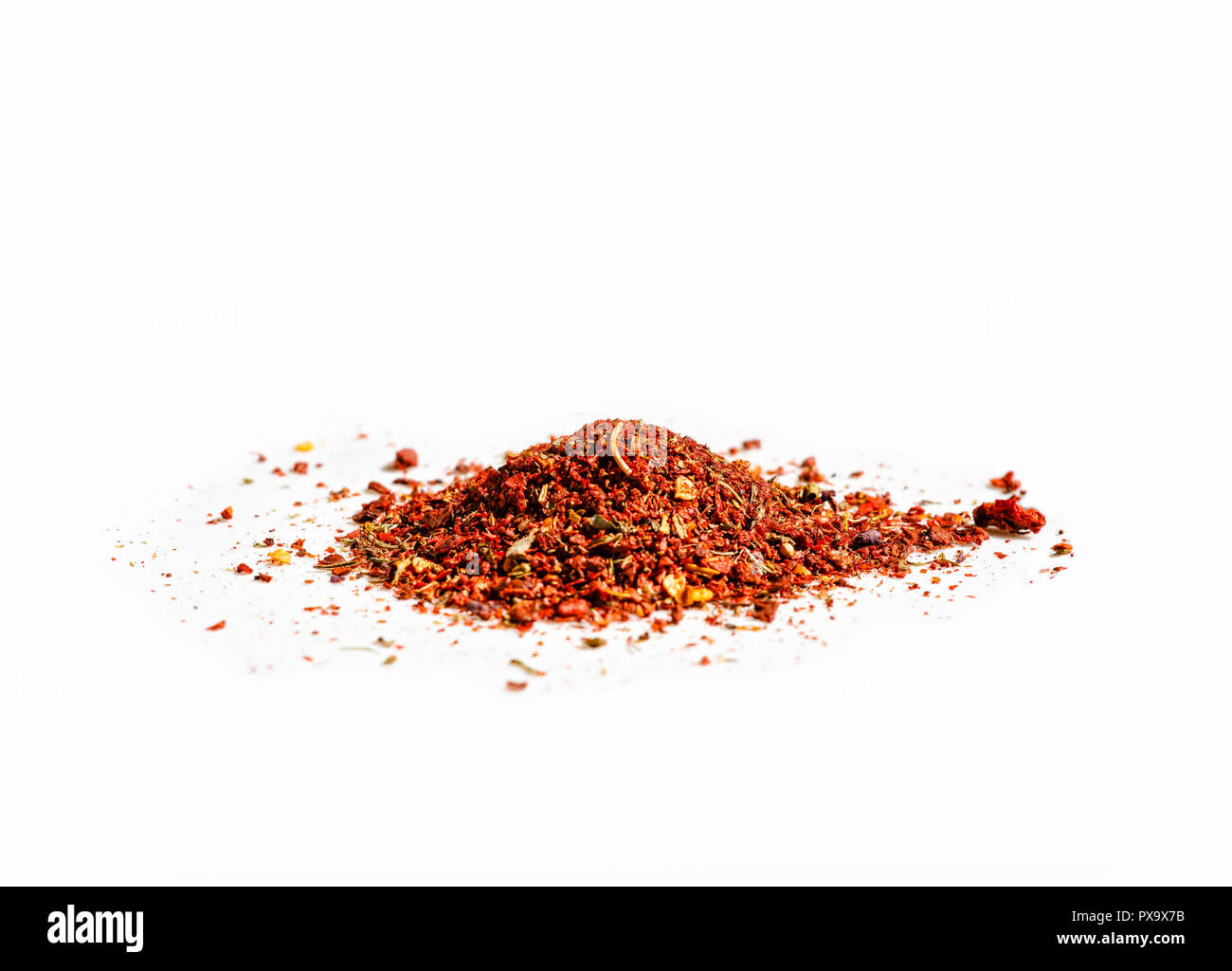 Pile of red pepper flakes on a white background Stock Photo - Alamy