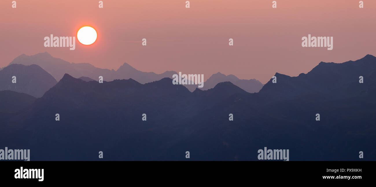 Mountain profiles, layers. Sun at sunrise. Austrian Alps. Europe Stock ...