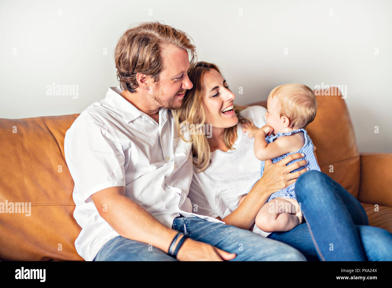 A nice Family having fun on sofa Stock Photo - Alamy