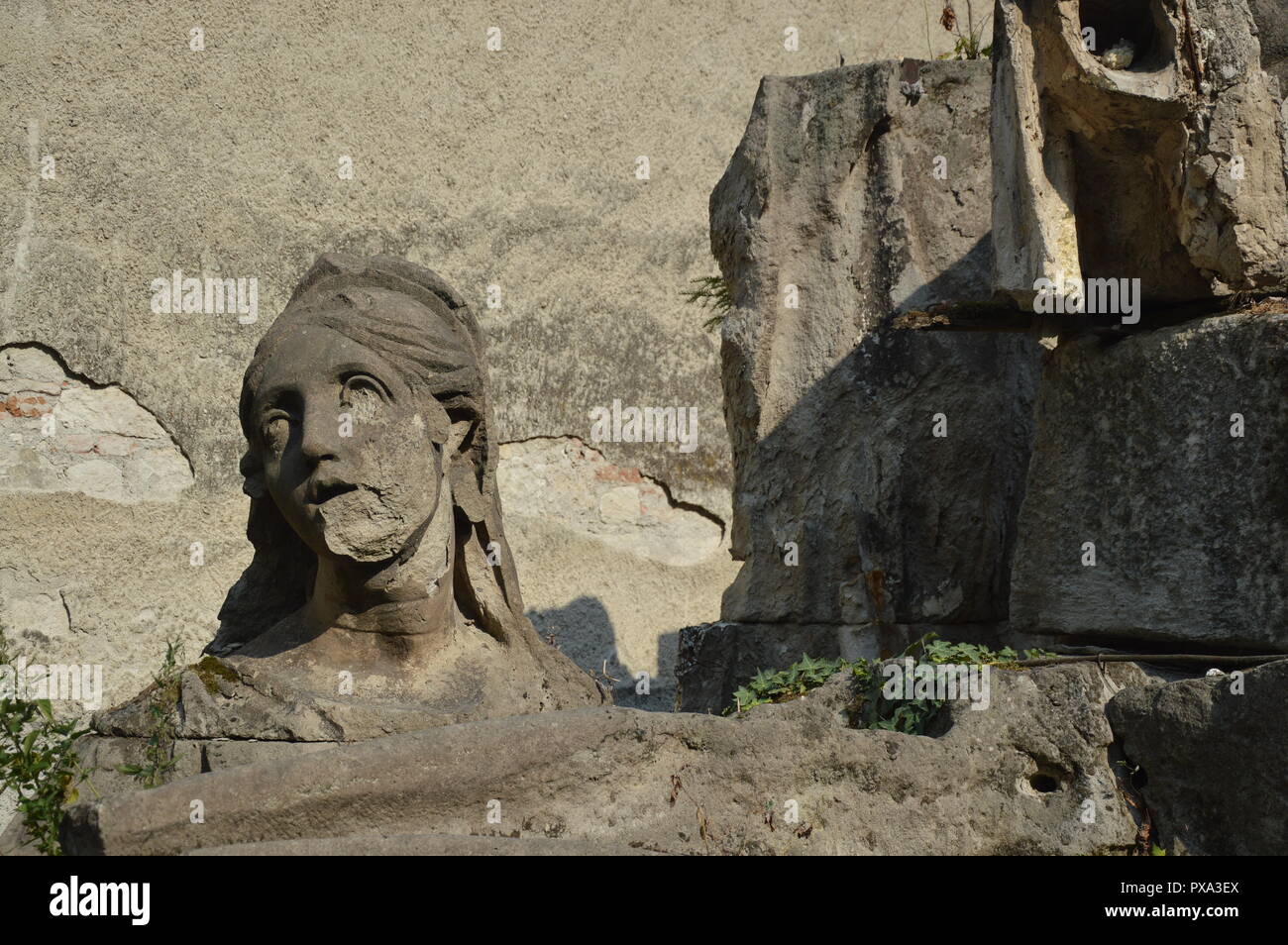 Pieces of old broken statues in a yard Stock Photo - Alamy