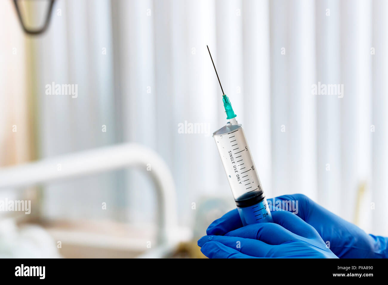 Hands in gloves hold syringe with injection Stock Photo - Alamy