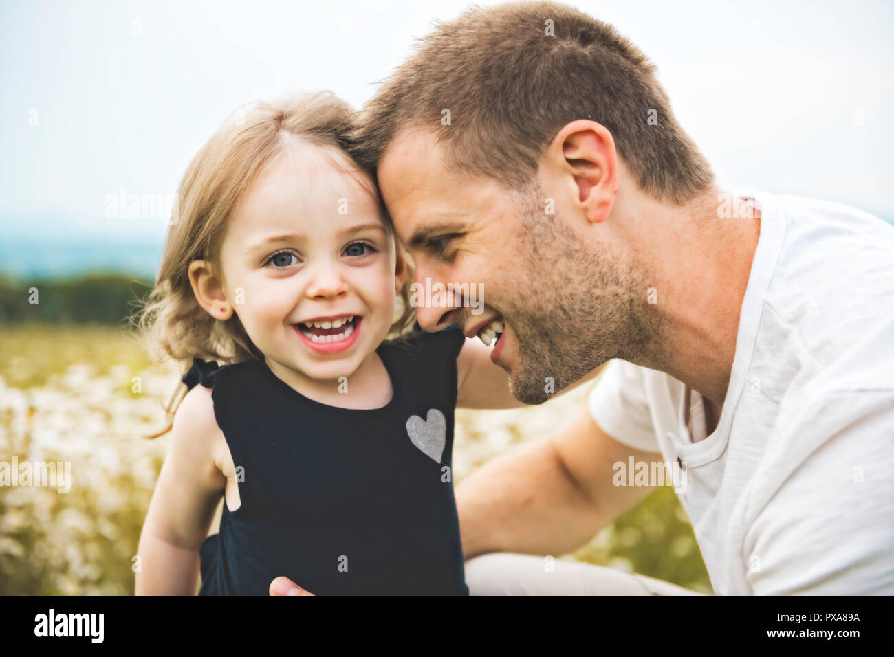 The father spending time with daughter during the sunset Stock Photo ...