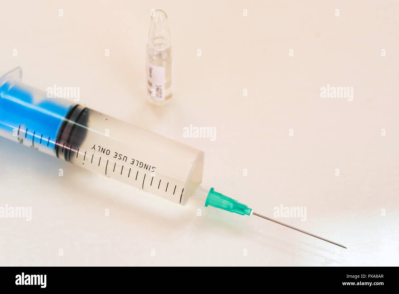 Syringe and a vial with medication on table close Stock Photo - Alamy