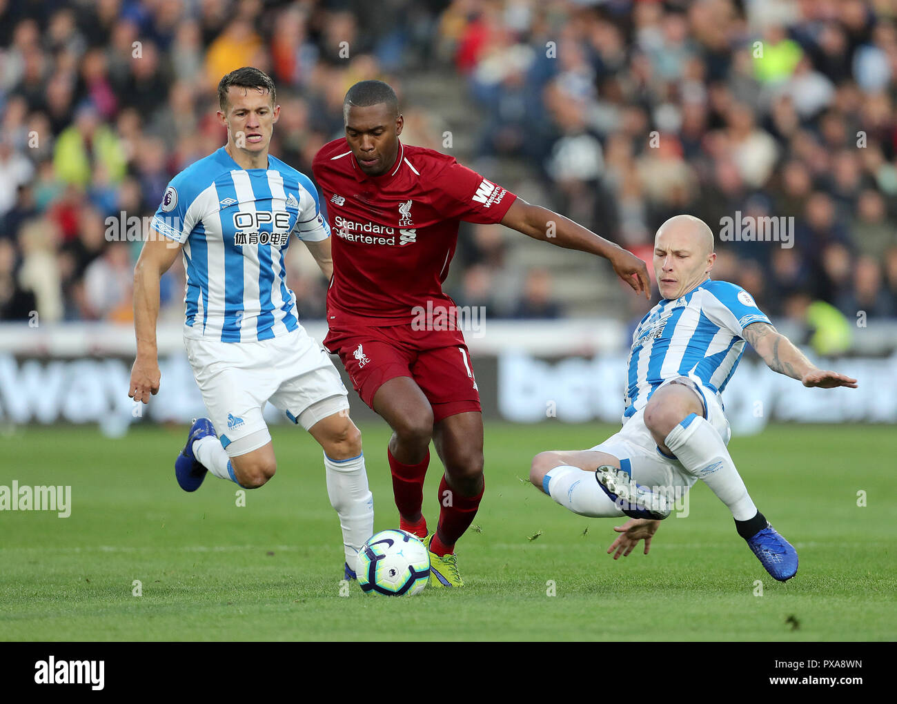 Liverpool's Daniel Sturridge (centre) battles with Huddersfield Town's ...
