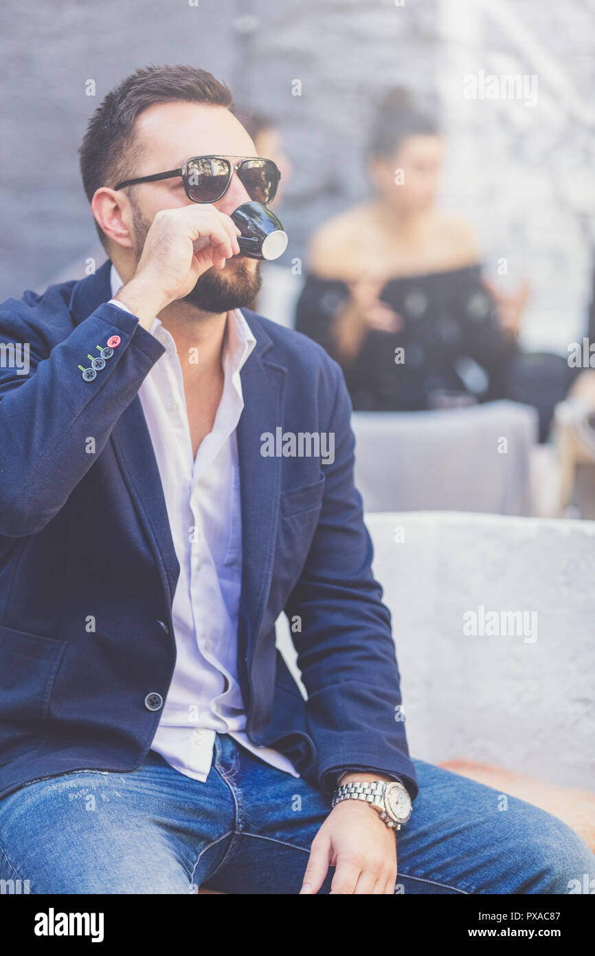 Urban guy drinking coffee in cafe Stock Photo - Alamy