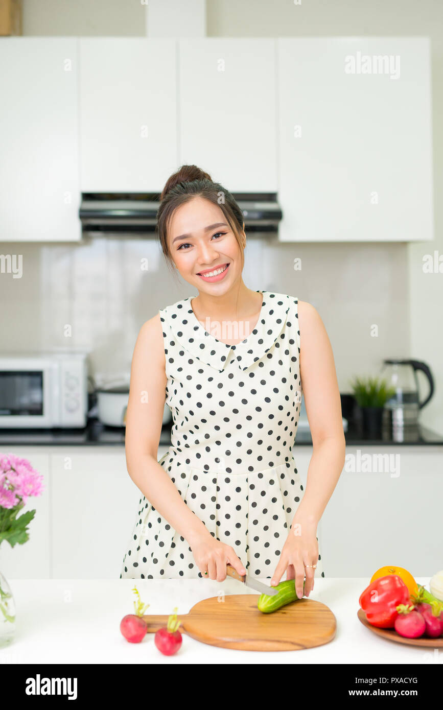 Portrait of young asian beautiful woman cooking in kitchen Stock Photo ...