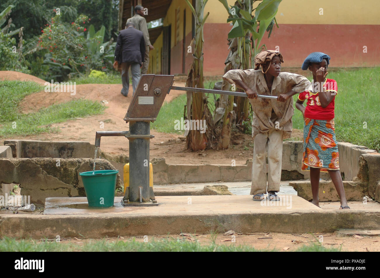 Boy filling bucket water in hi-res stock photography and images - Alamy