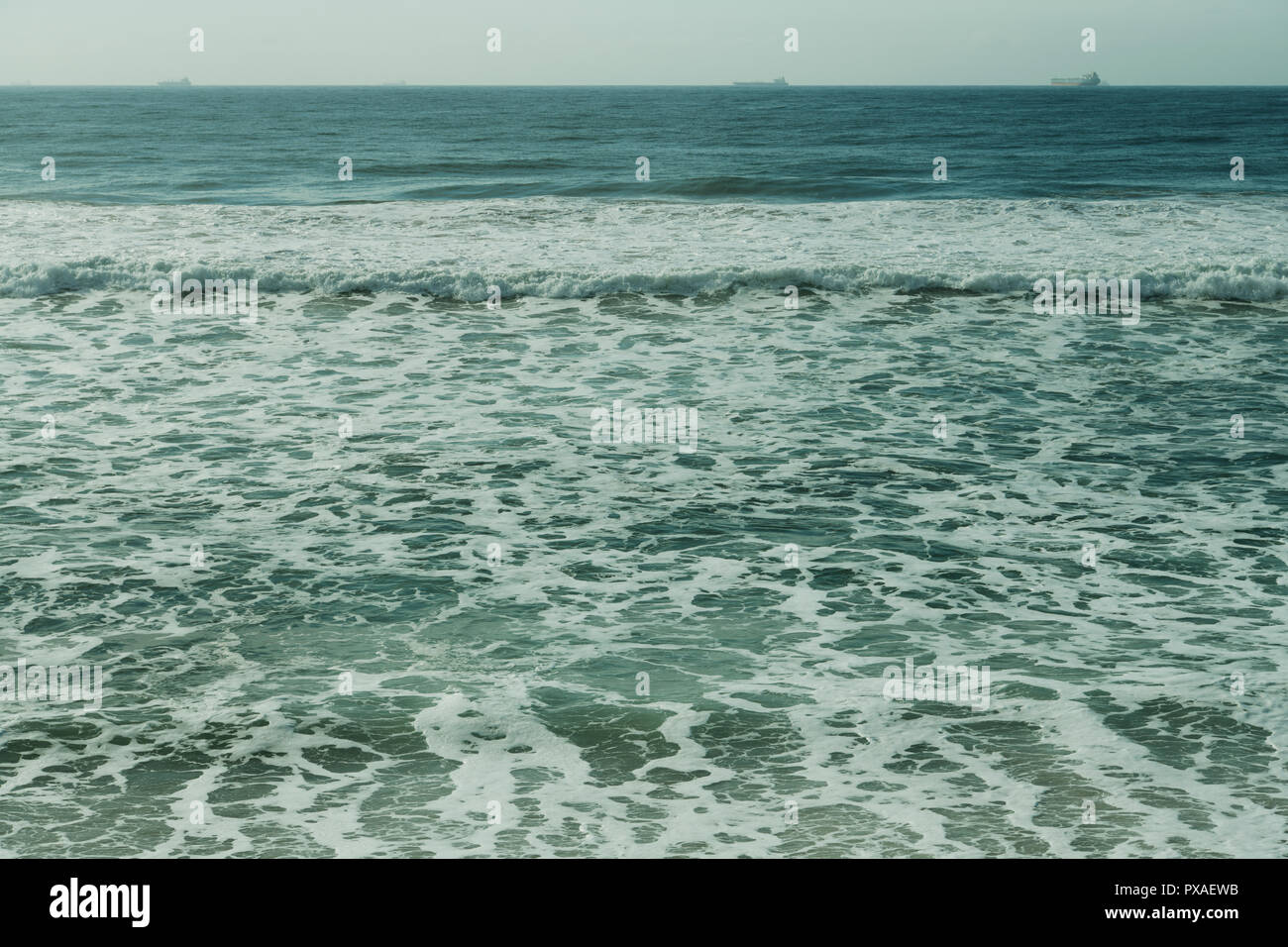 Durban, South Africa, ships on horizon of calm Indian Ocean, wave ...