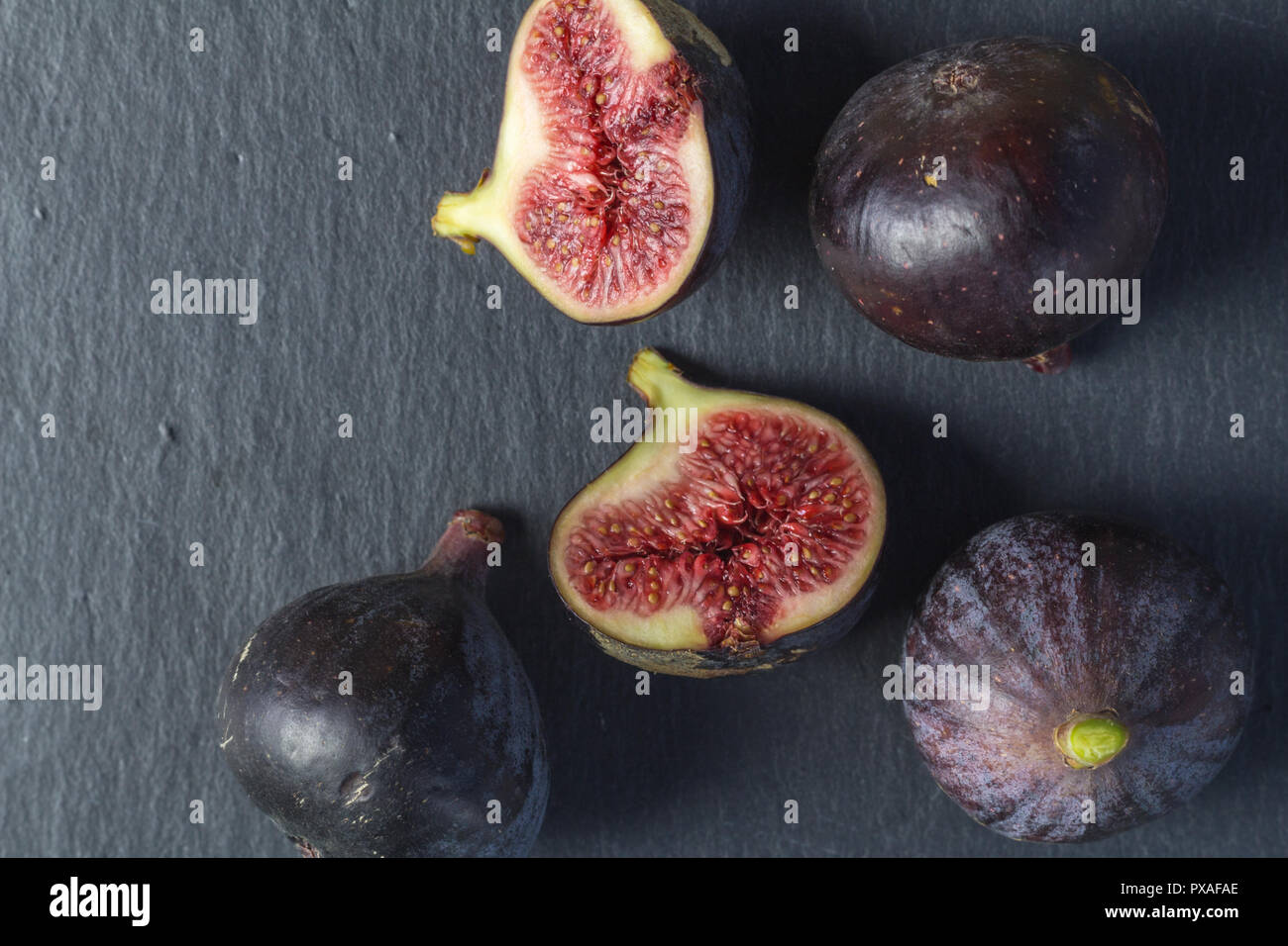 Figs isolated on black slate background - top view close up photo of ...