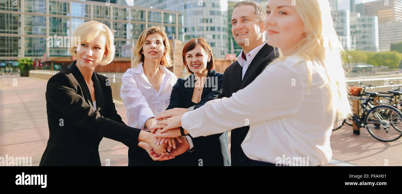 Prosperous business team rejoicing good result and greeting each other ...