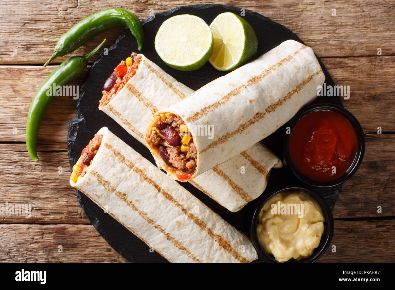 Fast food grilled burrito with beef and vegetables close-up on the ...