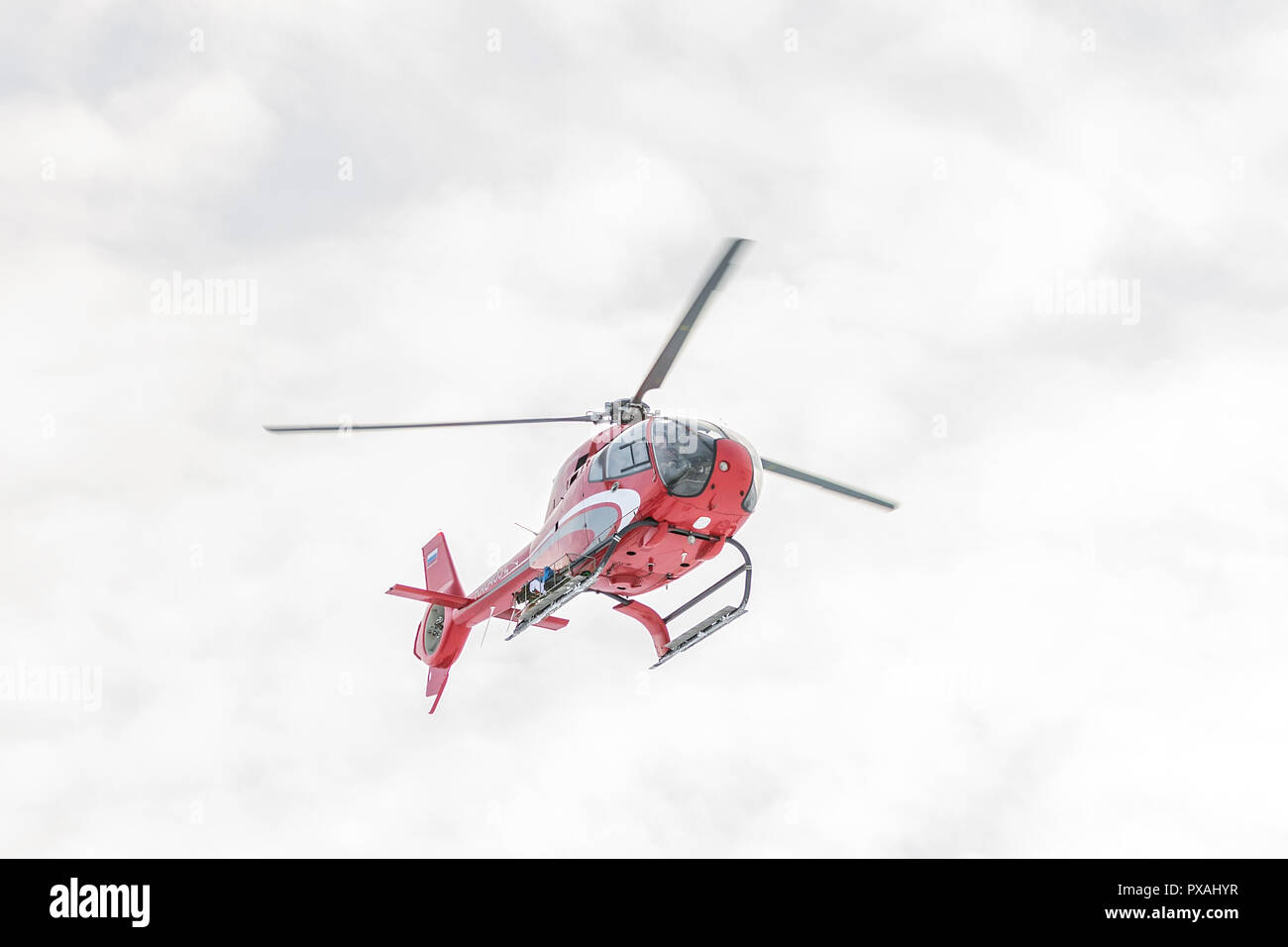 Red rescue helicopter fly in snowy mountains Stock Photo - Alamy