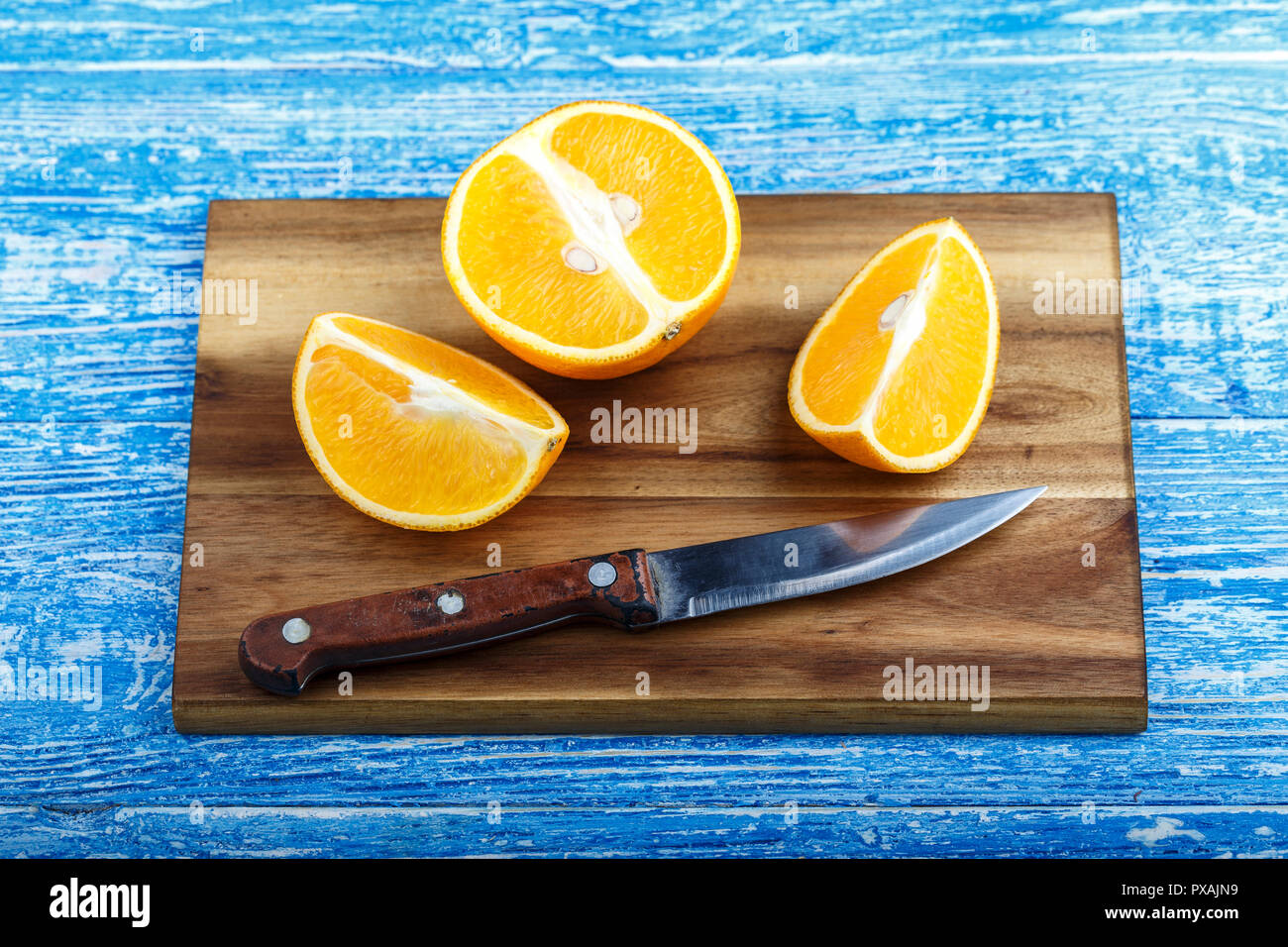 Cutted orange on a cutting board, next knife Stock Photo - Alamy