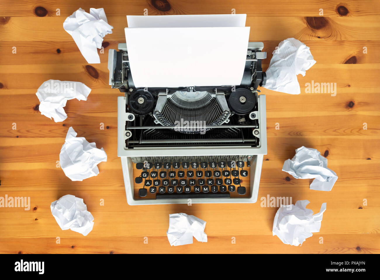 Writer's block. Typewriter and crumpled paper on work desk. Creative ...