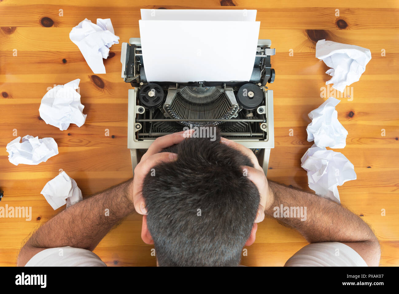Writer's block. Typewriter and crumpled paper on work desk. Creative ...