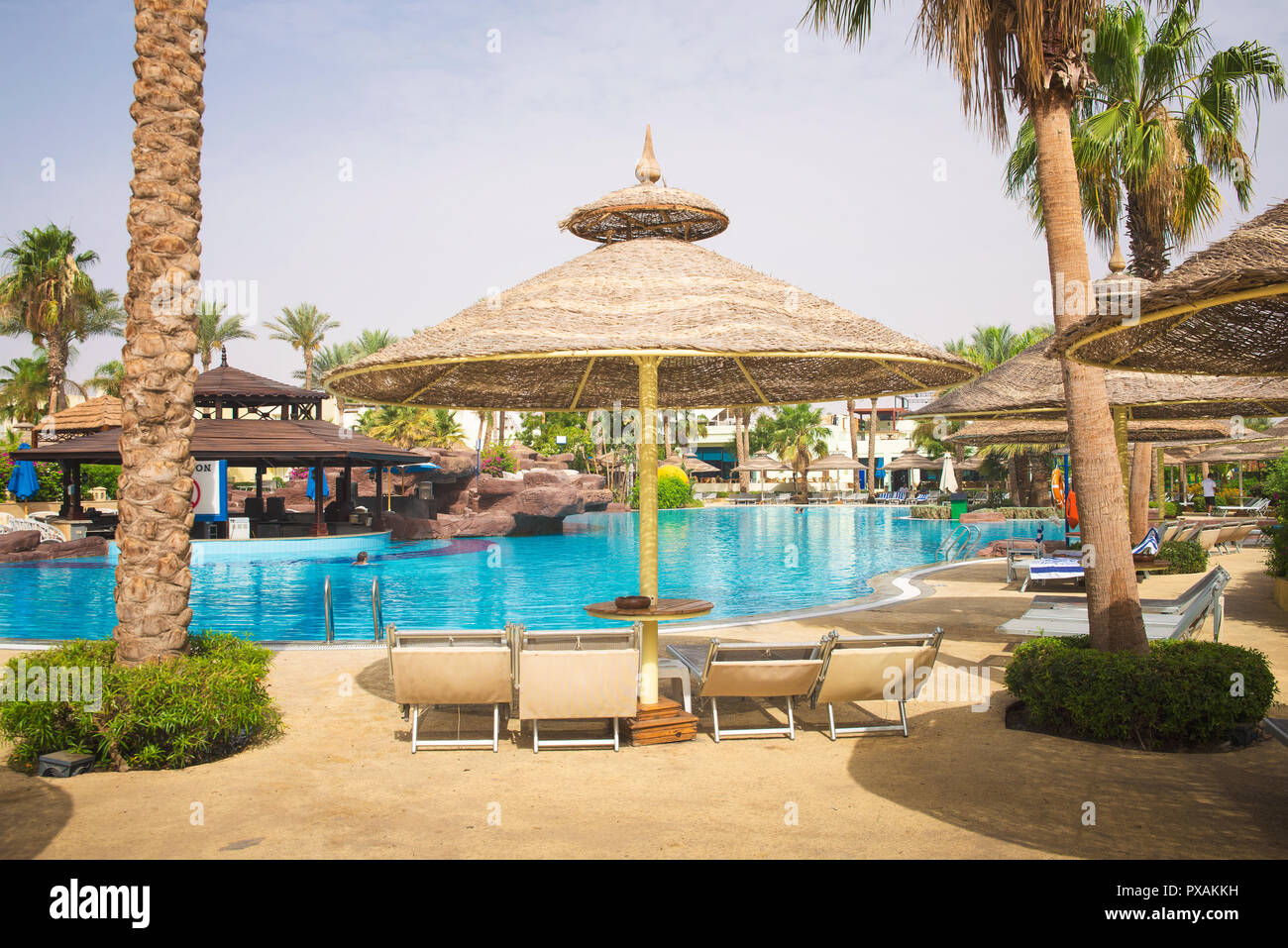 swimming pool with sun loungers Stock Photo - Alamy