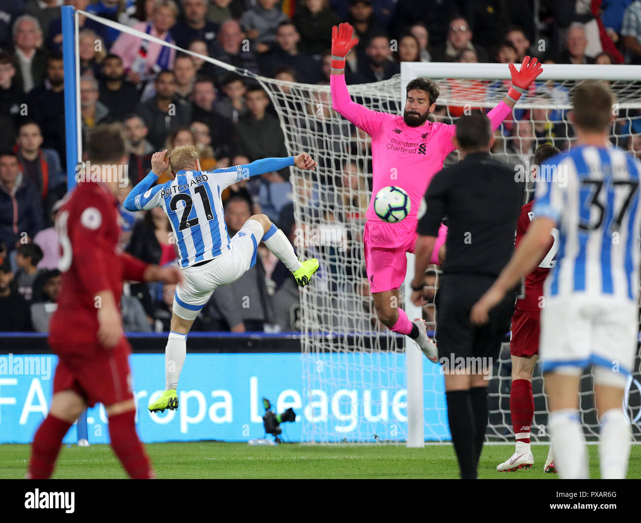 Liverpool goalkeeper Alisson Becker (right) makes a save from ...