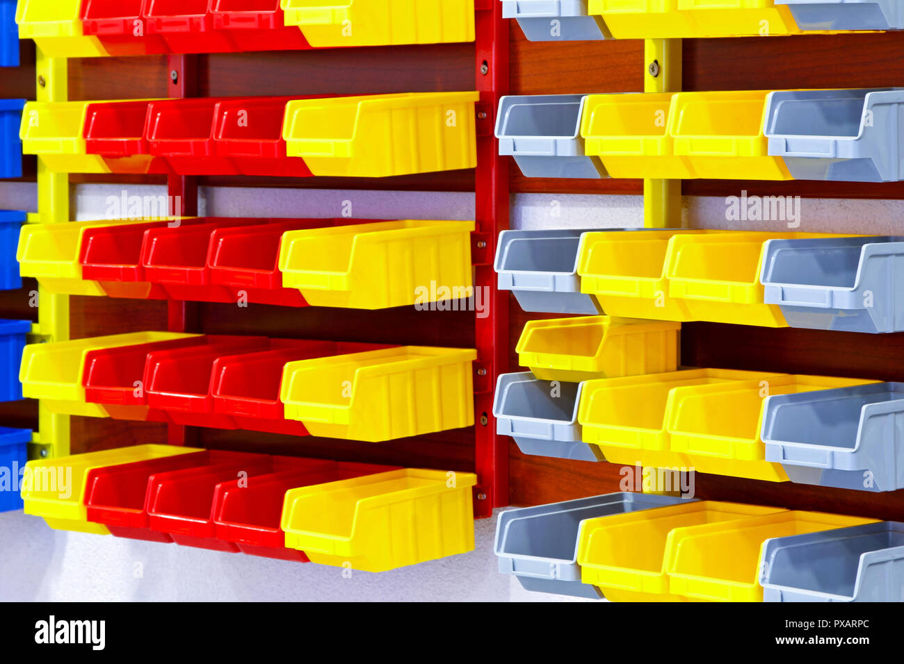 Open plastic boxes wall shelves in storehouse Stock Photo - Alamy