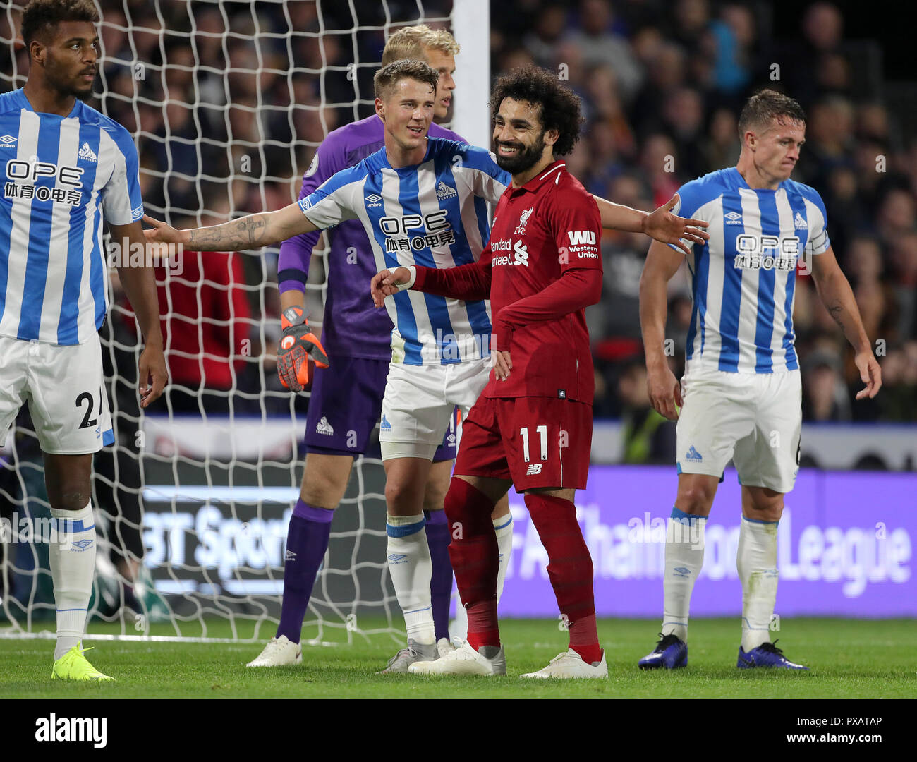 Huddersfield Town's Eric Durm (left centre) with Liverpool's Mohamed ...