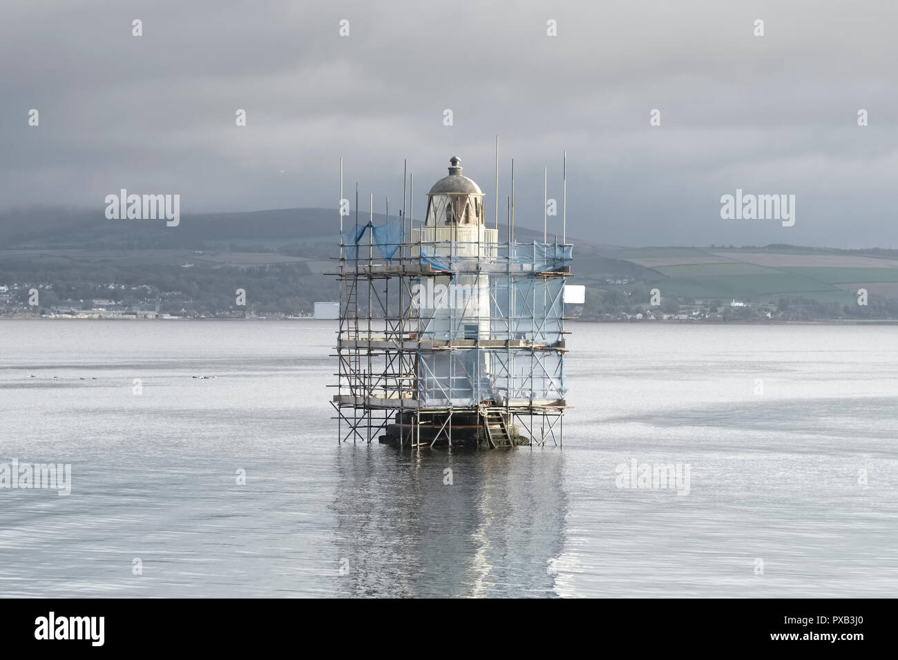 Lighthouse construction tall tower in sea water and bright light under ...