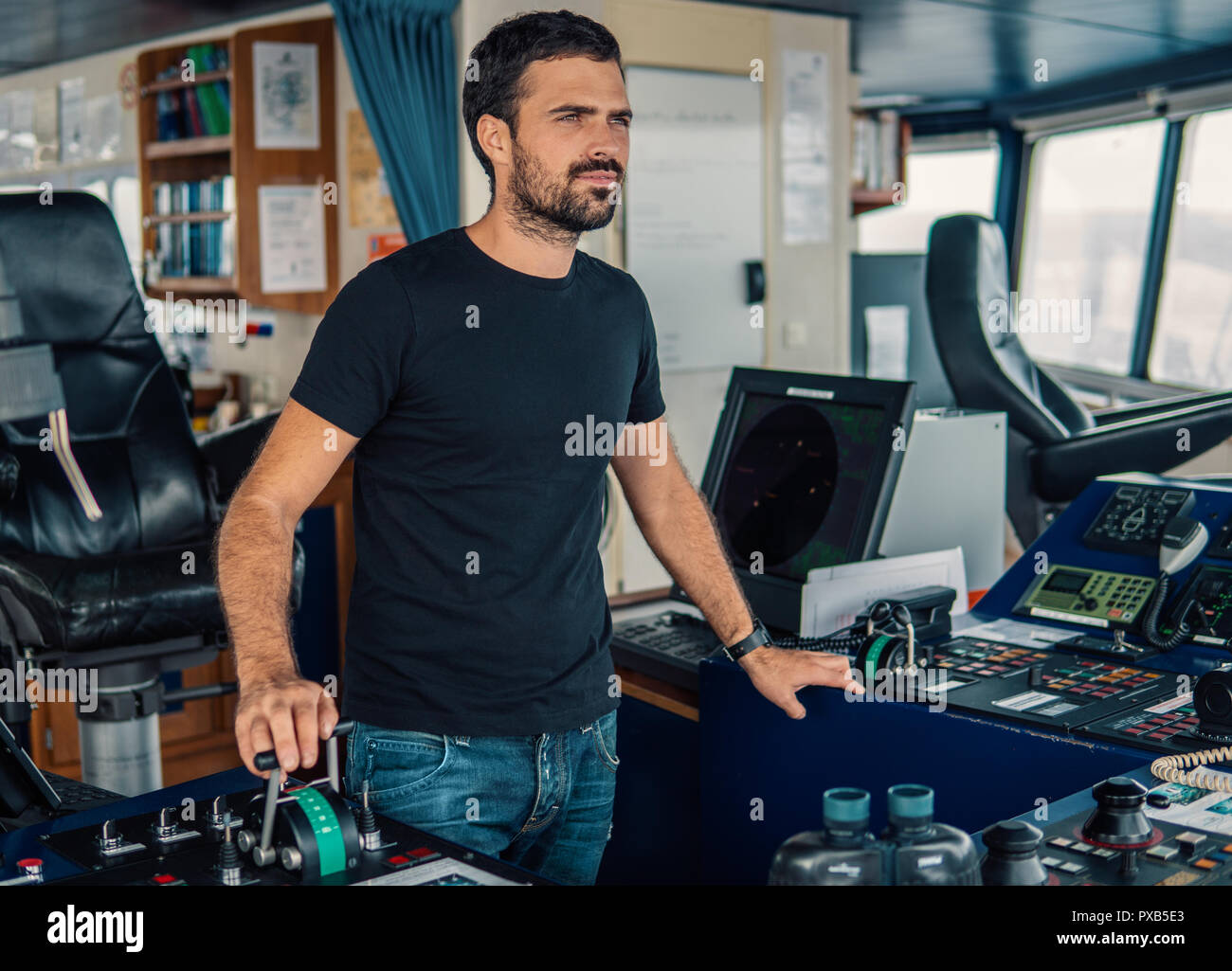 Marine navigational officer is maneuvering ship or vessel Stock Photo ...