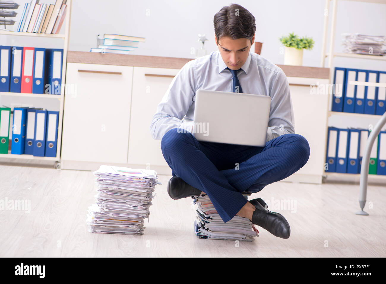Extremely busy employee working in the office Stock Photo - Alamy