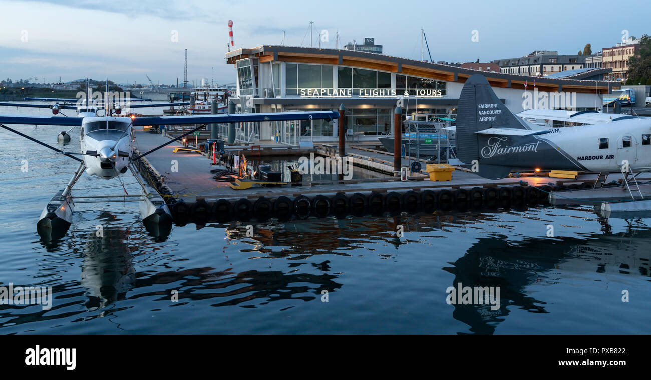 The Victoria Harbour Airport terminal with float planes at the dock in ...
