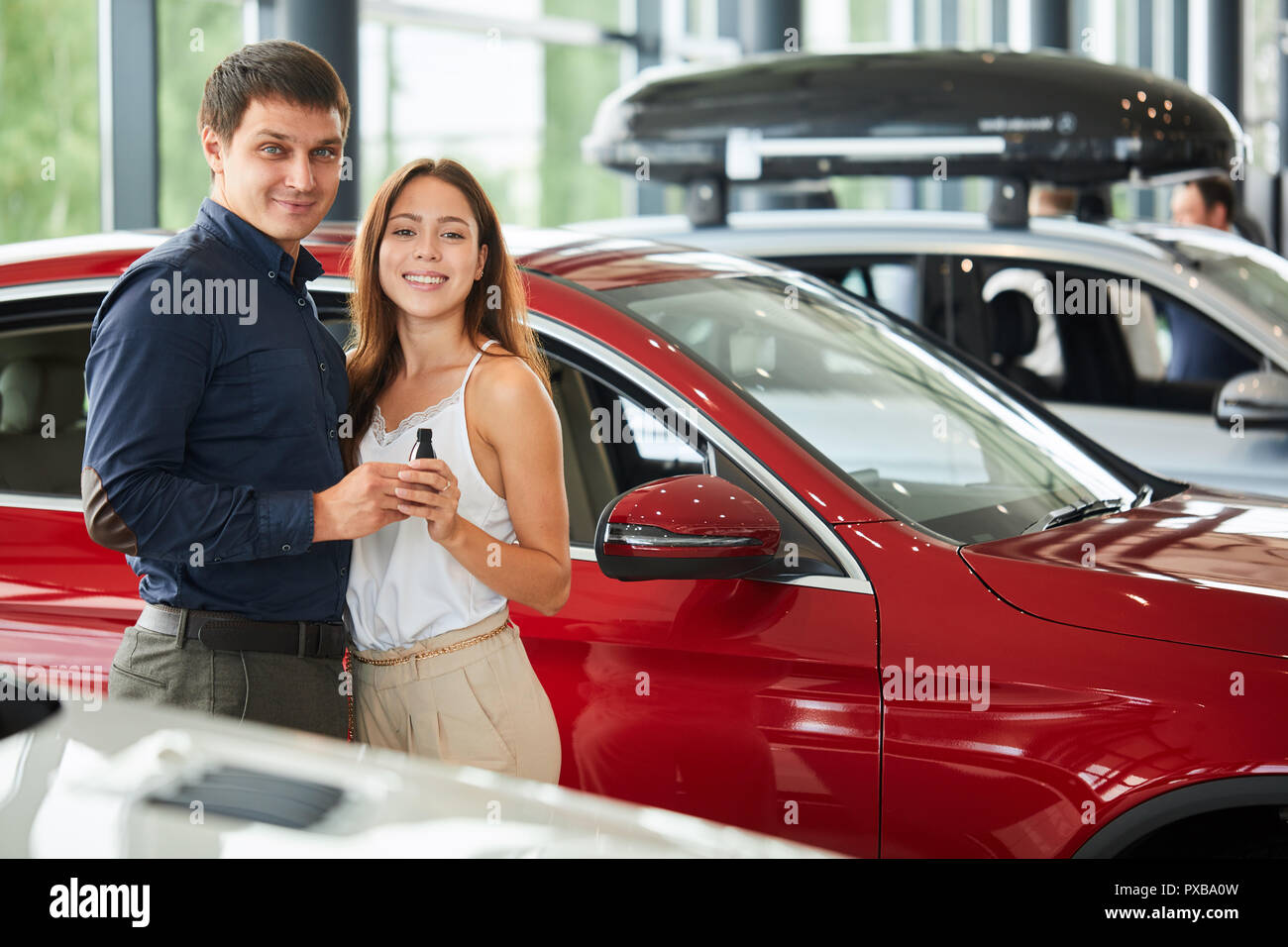 Embracing couple car owner hi-res stock photography and images - Alamy