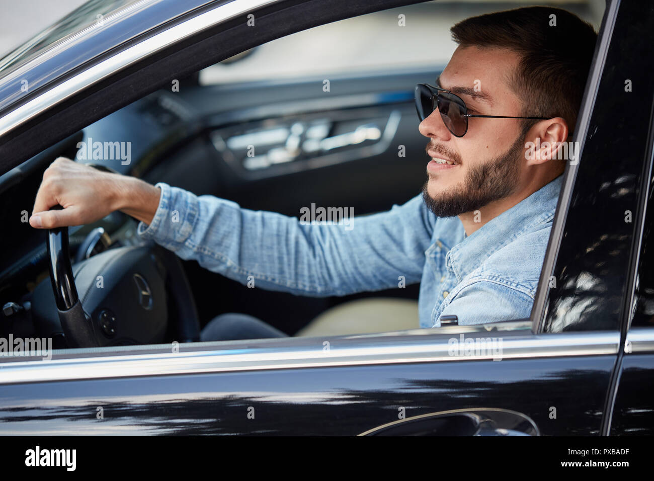 smiling bearded man renting a stylish car Stock Photo - Alamy