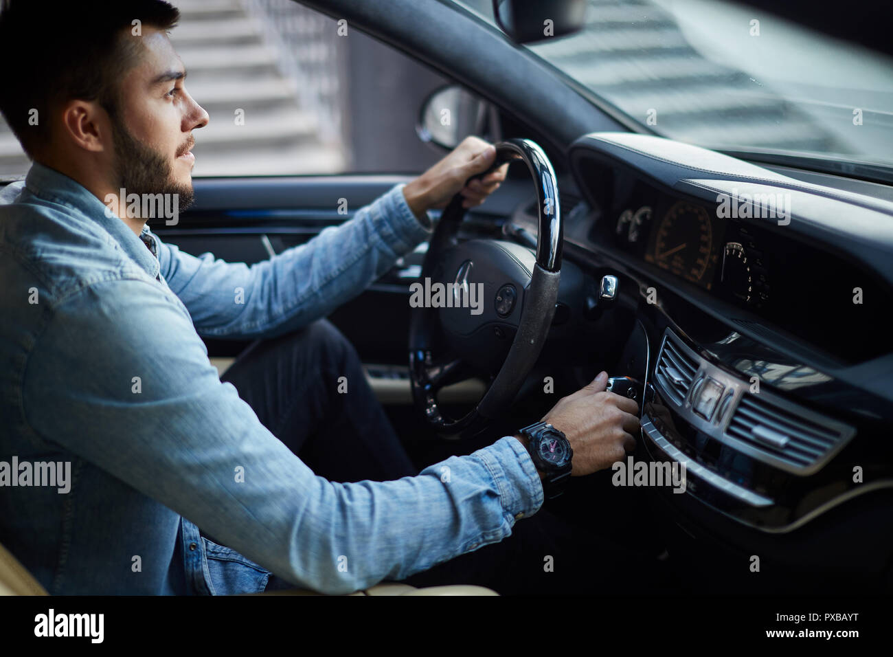attractive driver is turning on the vehicle Stock Photo - Alamy