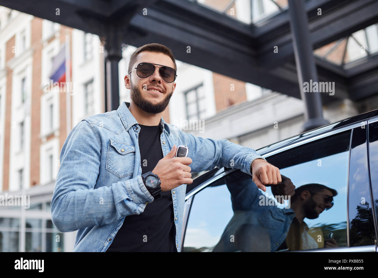 positive man is closing his car on alarm system Stock Photo - Alamy
