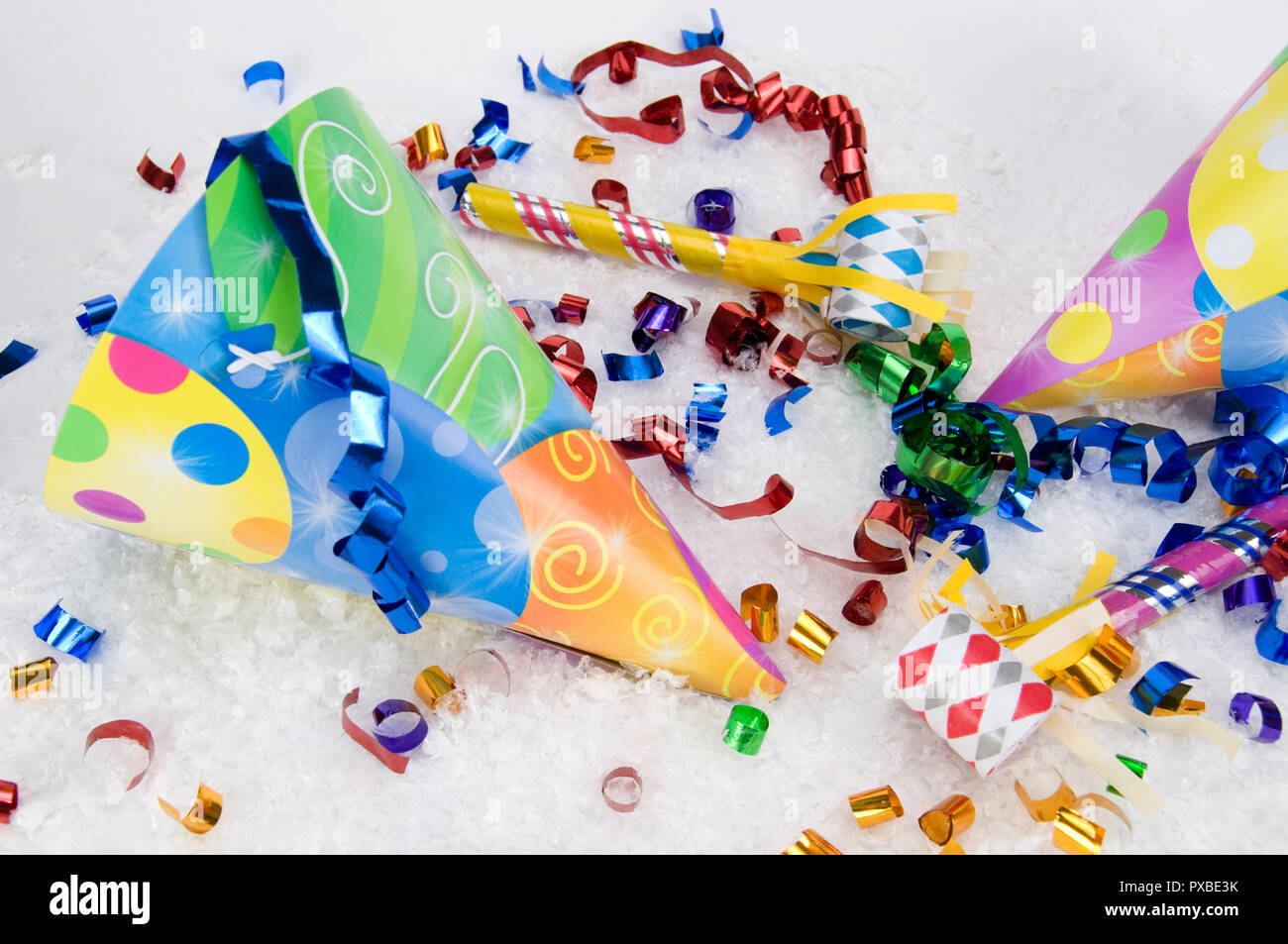 Party Hats, Whistles and Poppers on white Snow Stock Photo - Alamy