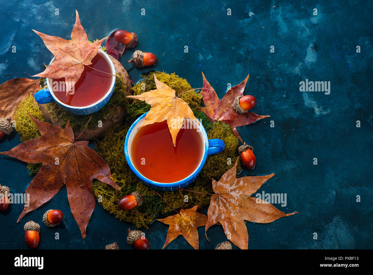 Autumn drink photography with hot tea in blue ceramic cups and fallen ...