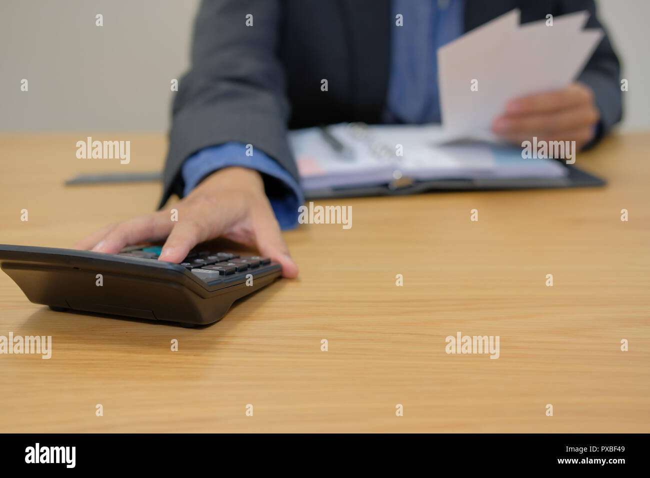 man calculate domestic bills. Businessman using calculator checking ...