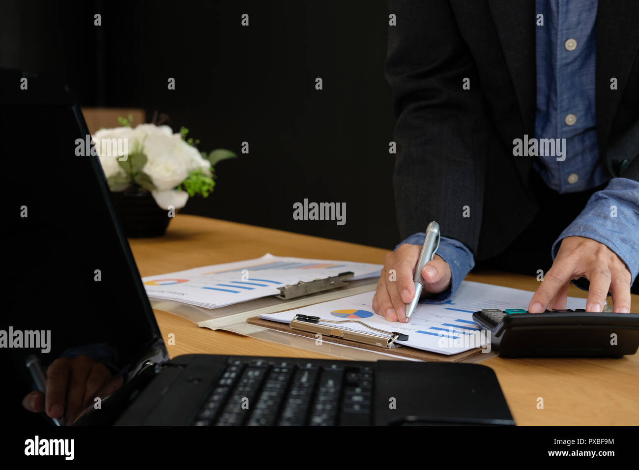 financial adviser working with calculator, business document at office ...