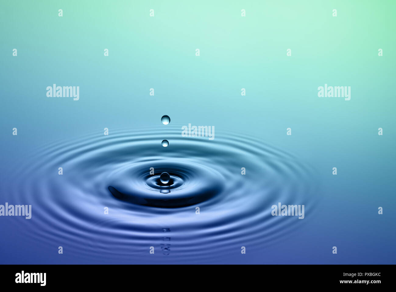 Splash closeup. Drop of rain fall on smooth water surface Stock Photo ...